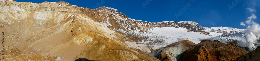 Panorama view of the snow-capped mountains of the Mutnovsky volcano and ...