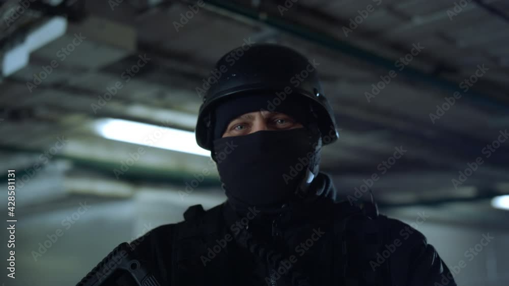 Focused SWAT police officer standing on position during special ...