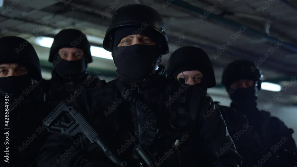 SWAT police officers posing at camera. Police special forces holding ...