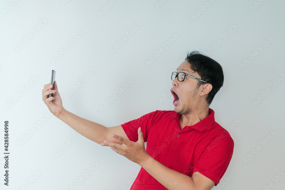 Wow face of Young Asian man shocked what he see in the smartphone on ...
