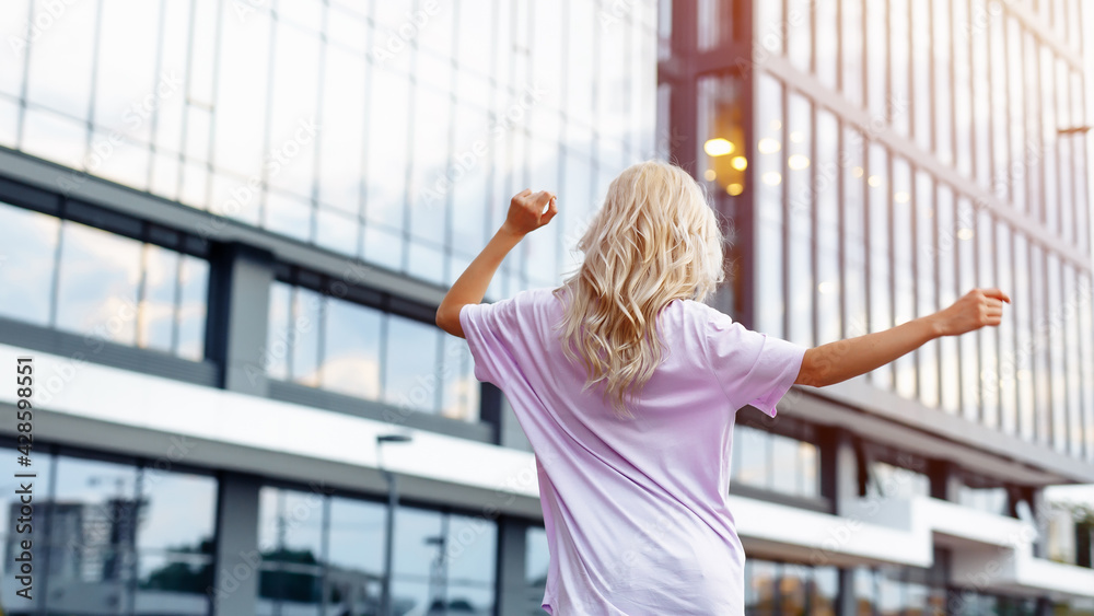 Blissful young woman expressing true emotions while posing on modern ...