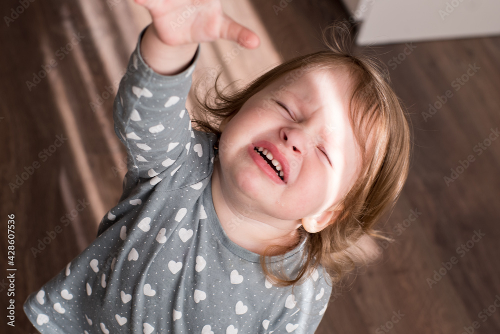the little girl is crying and acting up. the child is in a bad mood ...