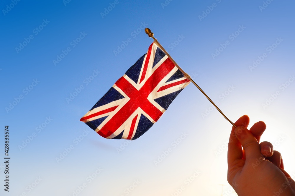 A hand holding the UK flag. A symbol of patriotism in the United ...