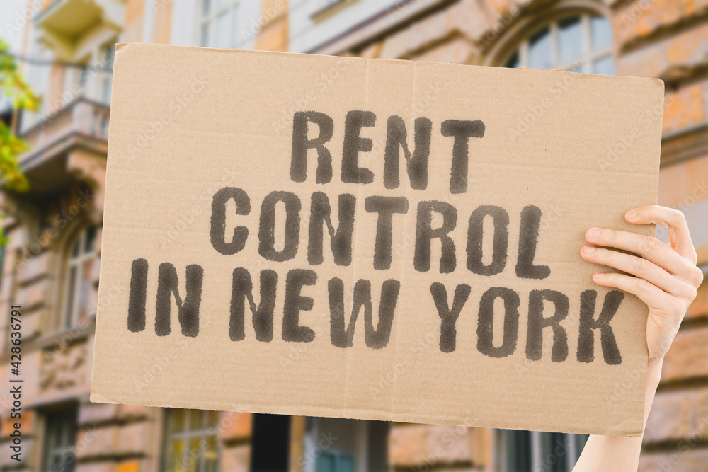 The phrase " Rent control in New York " on a banner in men's hand with ...