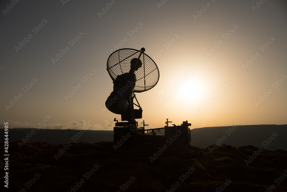 Space radar antenna on sunset. Silhouettes of satellite dishes or radio ...
