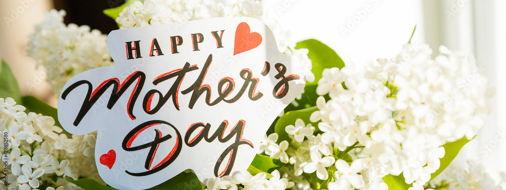 Lilac flowers and text Happy Mothers Day. Card with the lettering ...