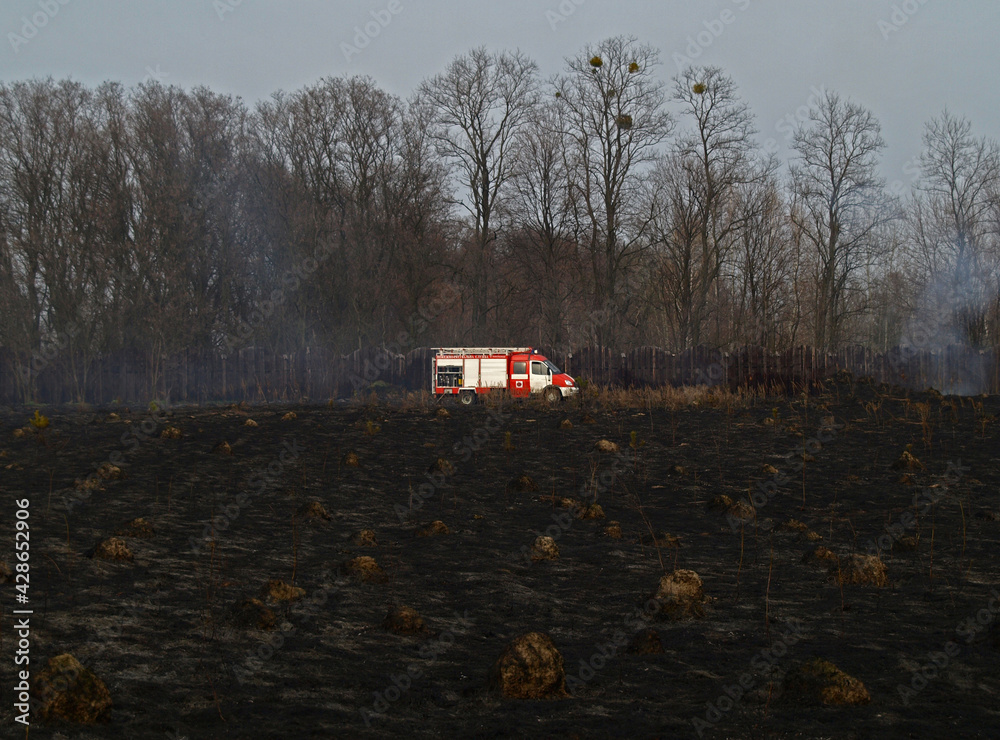 Fire engine. Black burnt earth. Conflagration. The fire that destroys ...
