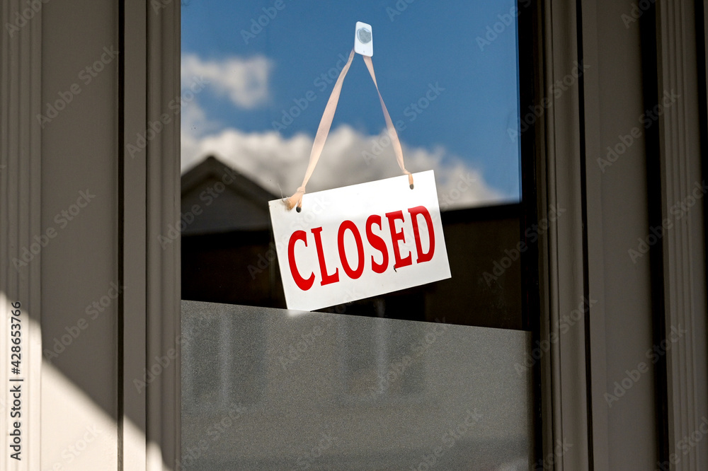 Closed sign in the window of a restaurant which was forced to shut ...