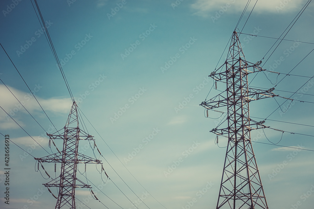 High voltage electric pylon and electrical wire with blue sky ...