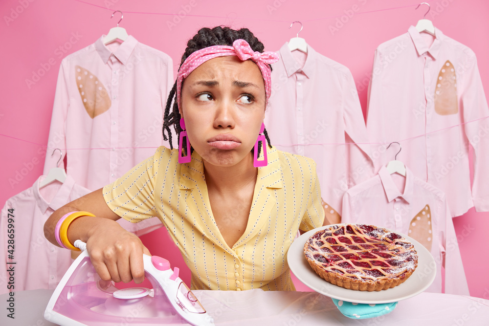 Housekeeping and domestic chores concept. Sad distressed dark skinned ...
