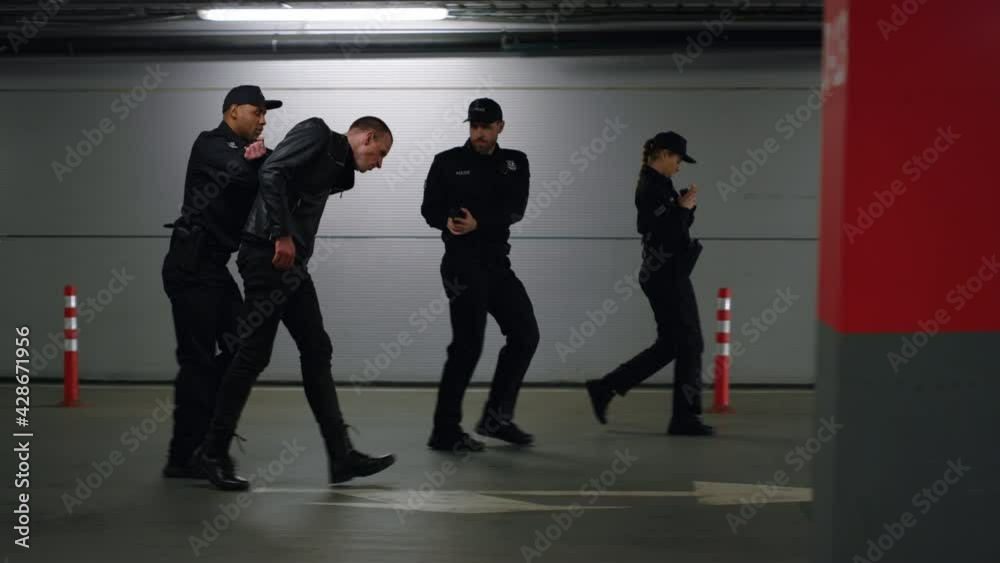 Police team arresting criminal. Police officers on duty walking with ...