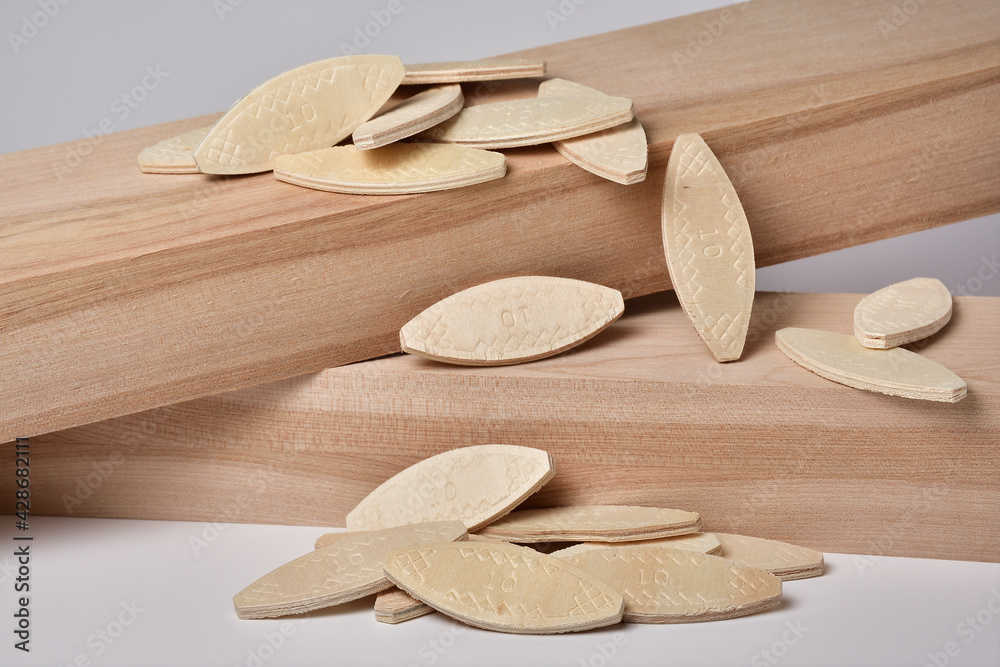 Biscuit joint and wood pieces isolated on white background, Woodworking ...
