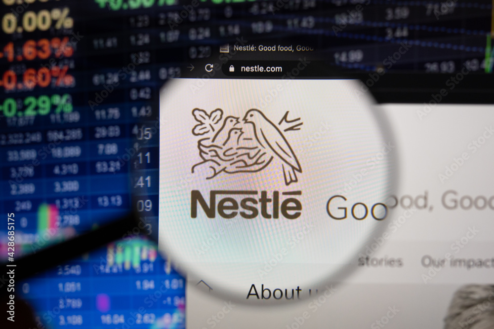 Nestle company logo on a website with blurry stock market developments ...