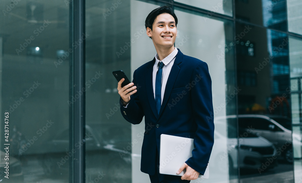 Image of Young asian businessman with glass building background Stock ...