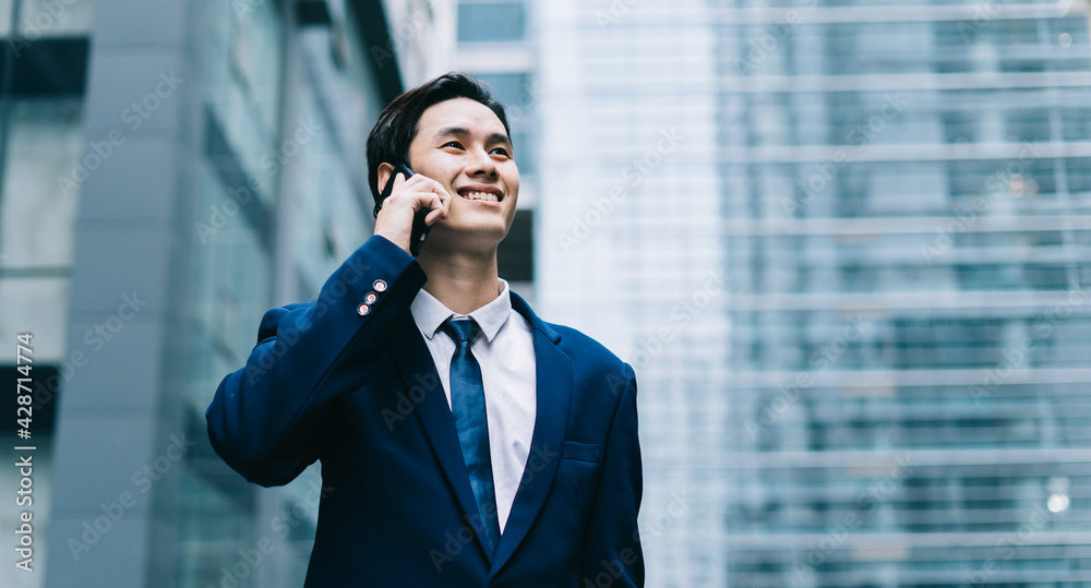 Image of Young asian businessman with glass building background Stock ...