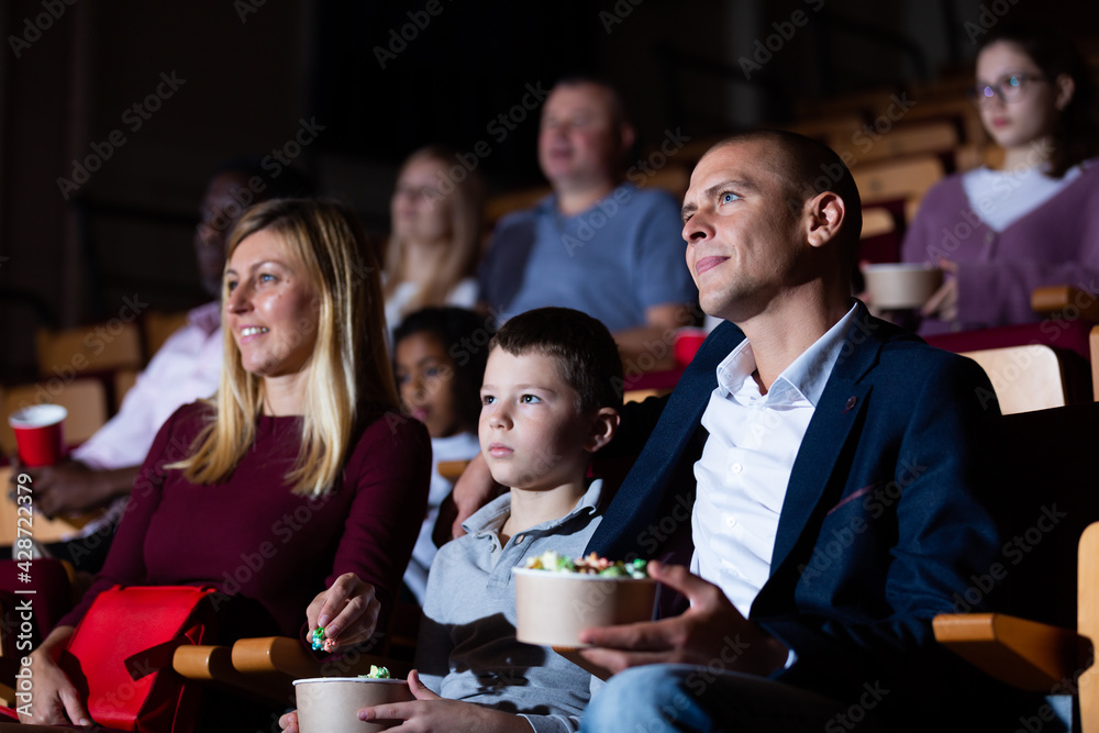 Family spending time together in cinema. Selective focus of young ...
