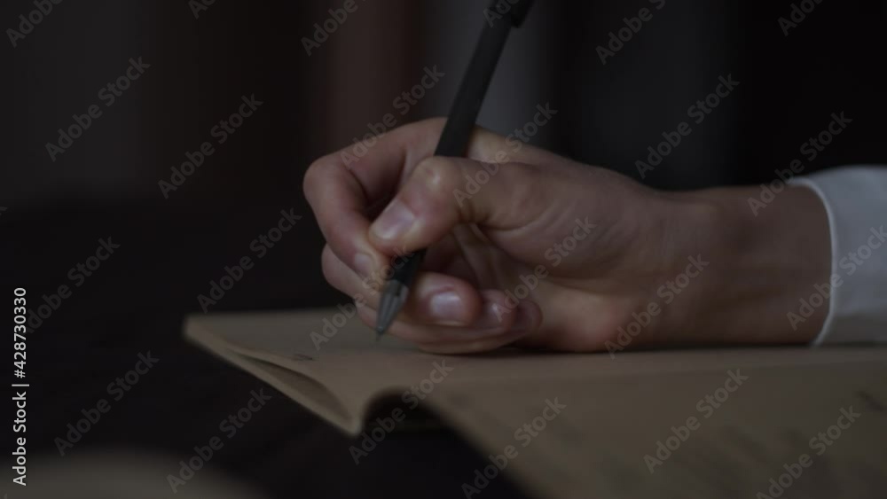 Macro close-up view of female hand making notes, writing letter in ...