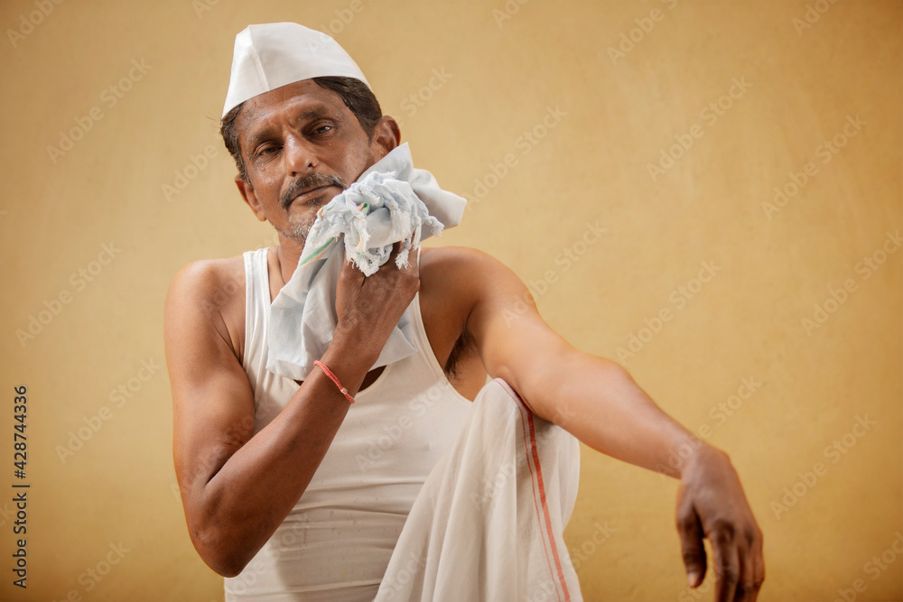 Farmer from west india wiping off his sweat Stock Photo | Adobe Stock