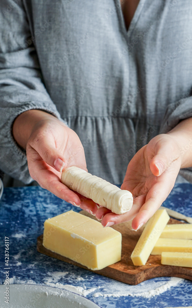 tequeno typical snack of venezuelan food - woman chef making tequeños ...