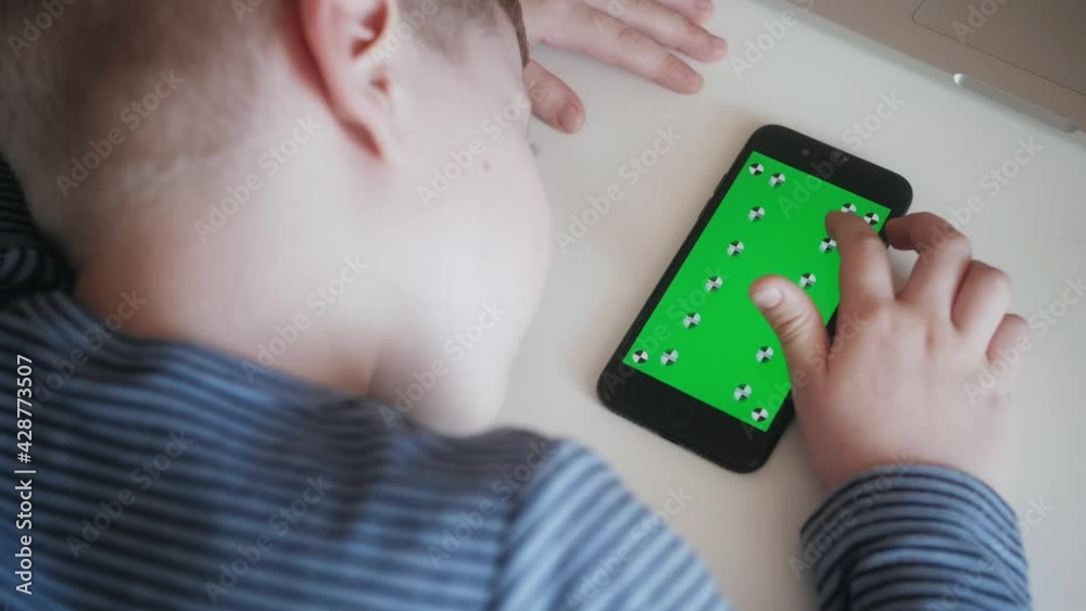 Close-up hand of kid boy with smartphone. Child holding smartphone with ...