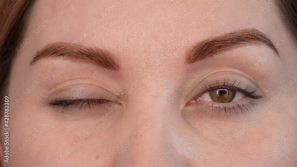 Cute girl sight blinking after the procedure for coloring female ...