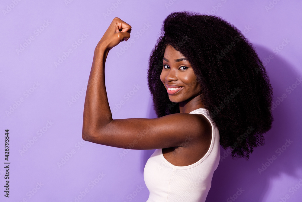 Profile photo of charming positive dark skin girl arm flex show biceps ...