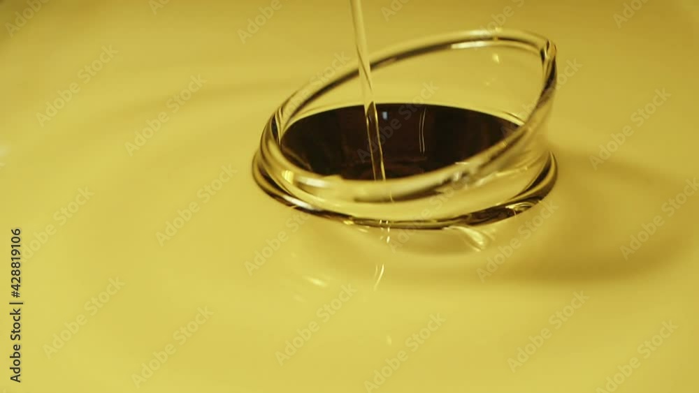 Drops of oil falling in pond and making ripple in slow motion Stock ...