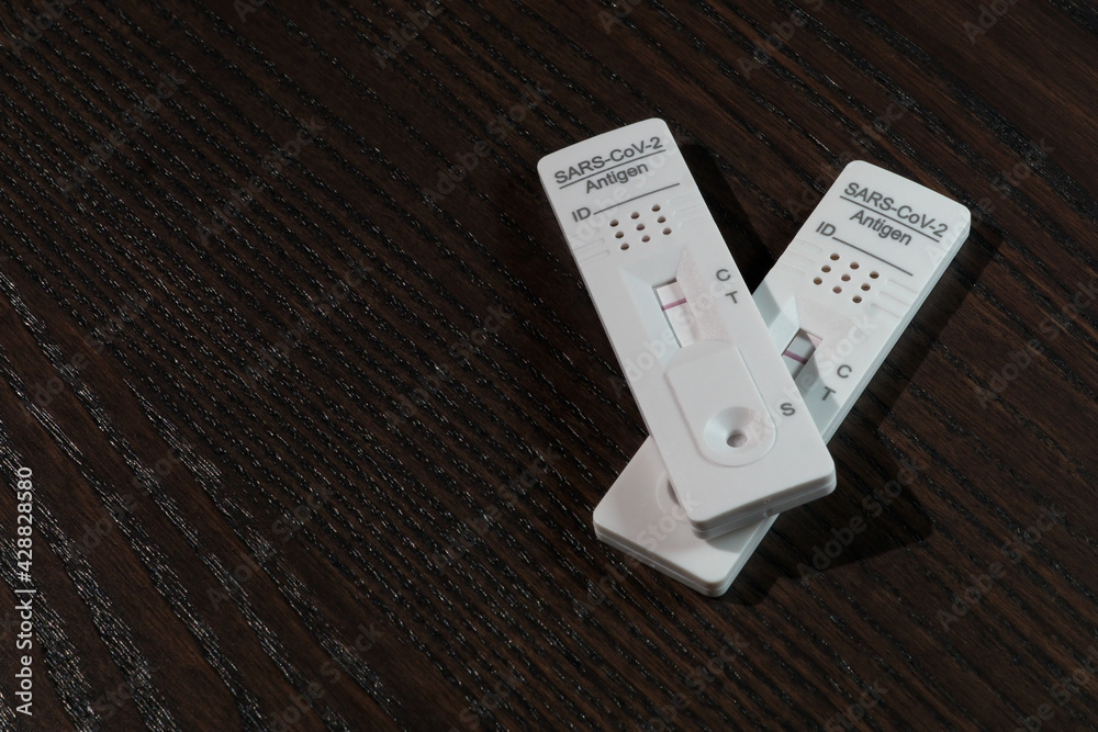 Two negative rapid antigen SARS-CoV-2 tests on a table. This is a test ...