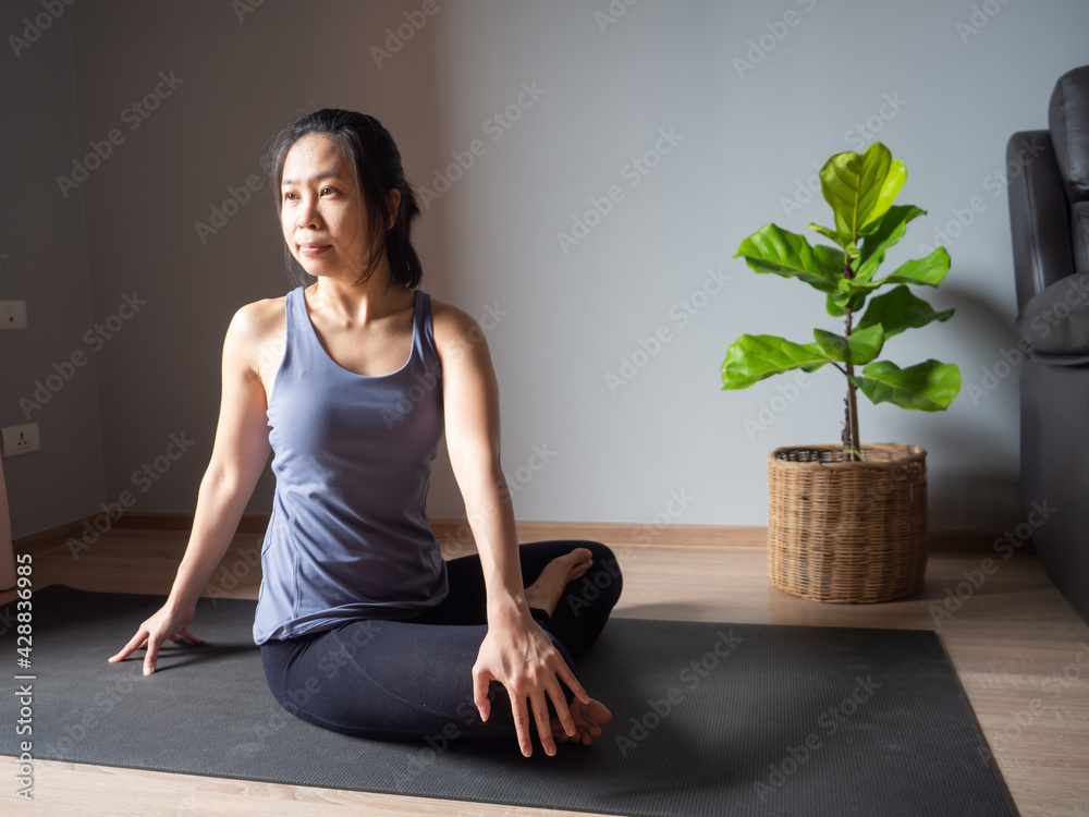 seated spinal twist pose yoga asian woman home workout fitness body ...
