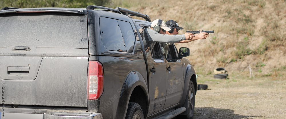 Military tactical car shooting. Army soldiers in action. Outdoor ...