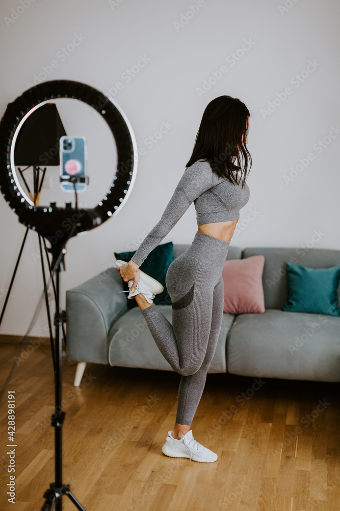 Virtual online fitness. Woman virtual workout at home living room ...