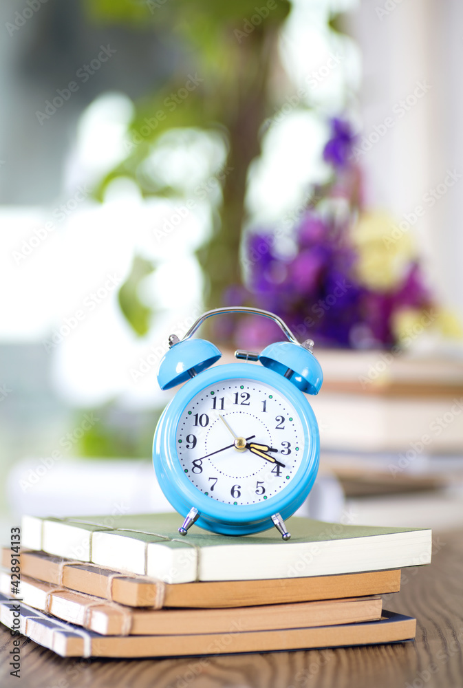 Books and alarm clock Stock Photo | Adobe Stock