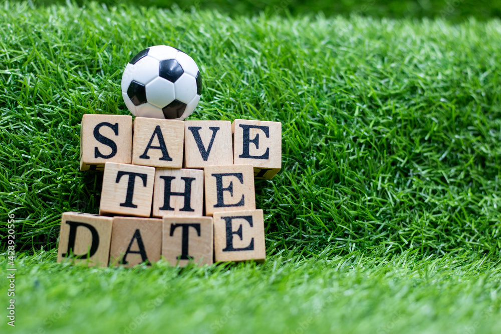 Soccer ball with save the date on green grass for party invitation ...