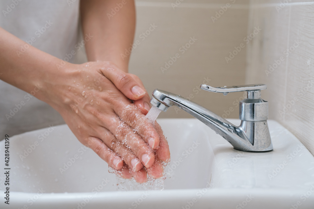 Lady wash and rinse hand to prevent the spread of bacteria and virus ...
