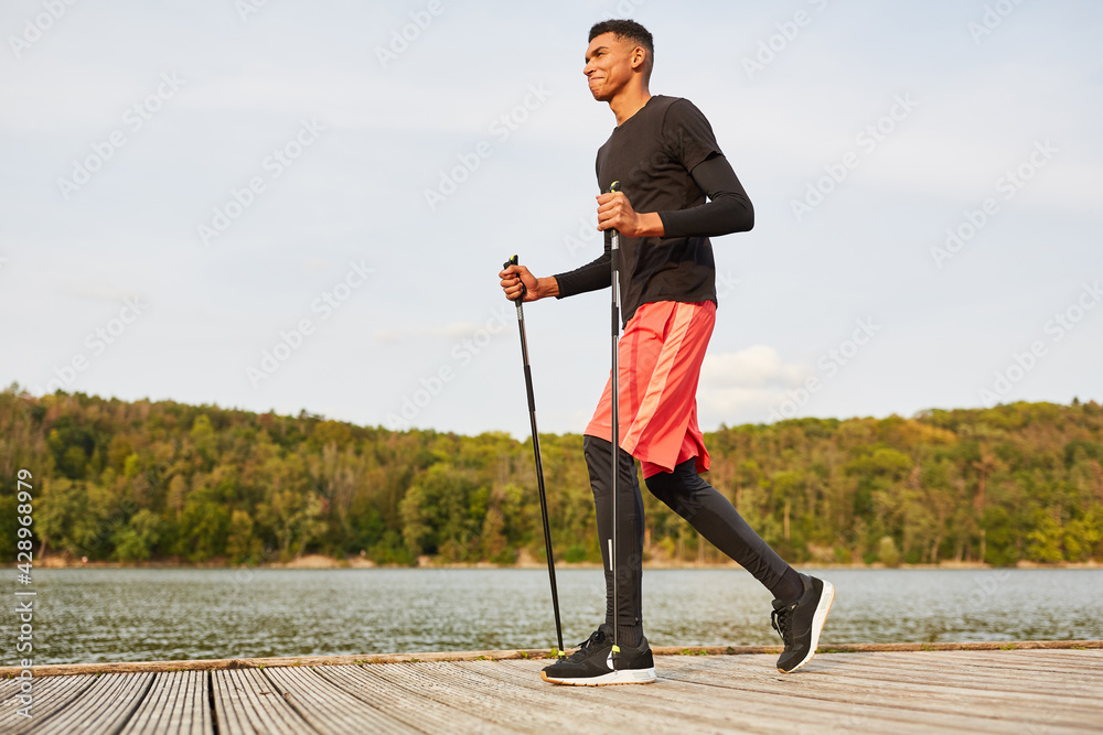 Man trains fitness while Nordic walking Stock Photo | Adobe Stock