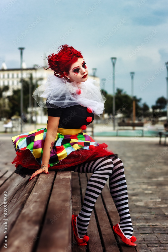 Beautiful young woman dressed as a clown, Beautiful girl dressed as a ...