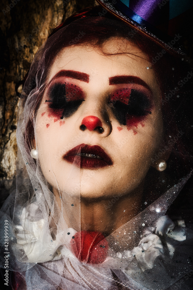 Beautiful young woman dressed as a clown, Beautiful girl dressed as a ...