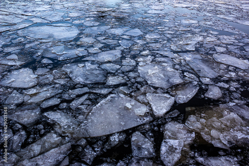 Broken ice of dark blue color on the river. Chunks of crushed ice on ...