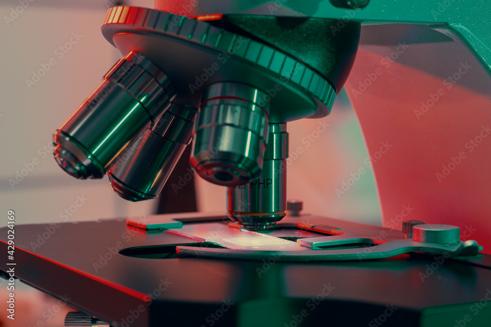 Toned photo of a backlit microscope lens in a science laboratory Stock ...