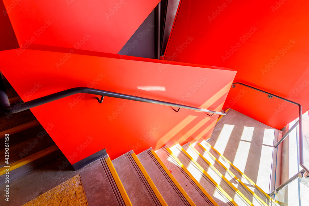 Staircase painted in red. Abstract fragment of the architecture of ...