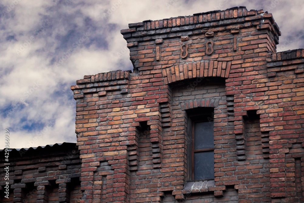 the top of old brick house of a 19th-century with number 1881 as year ...