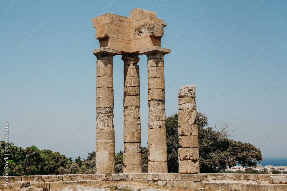 Acropolis of Rhodes with trees behind it under a clear blue sky in ...