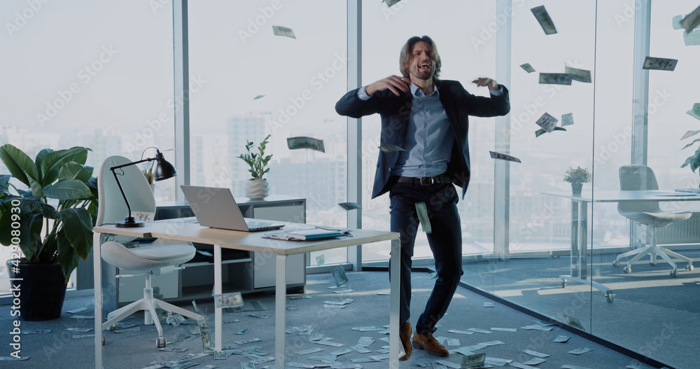 Emotional young rich businessman dance in money rain celebrating ...