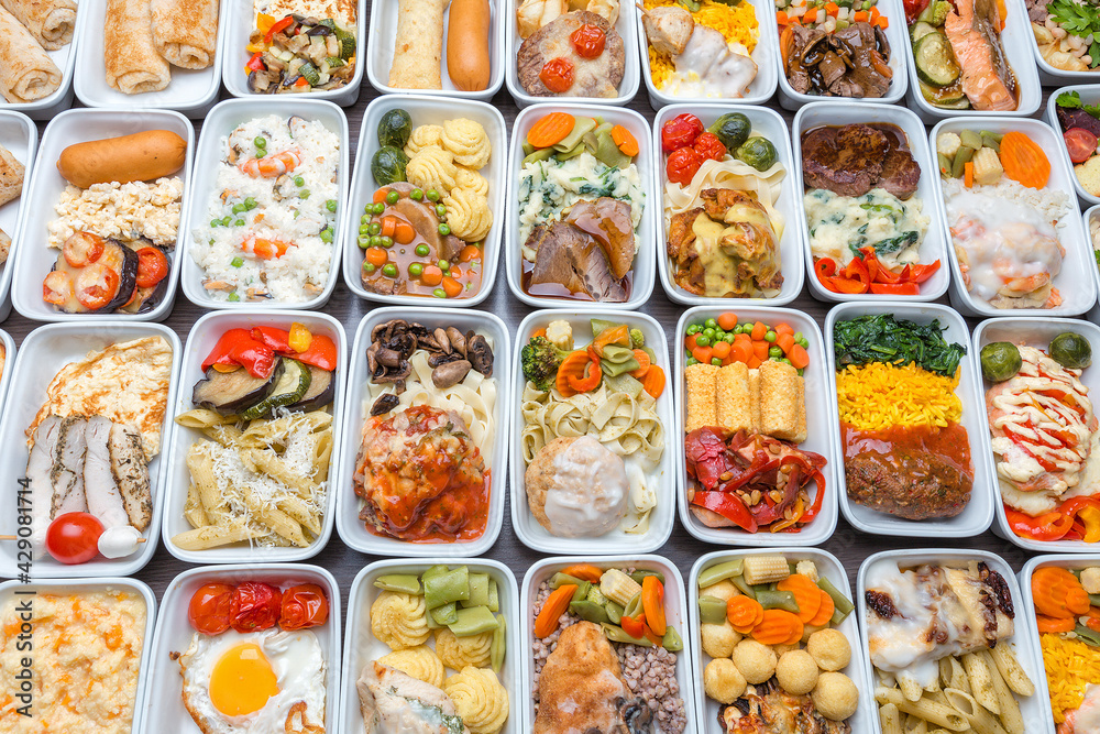 Airplane food presentation with variety of in flight meals. Flight ...