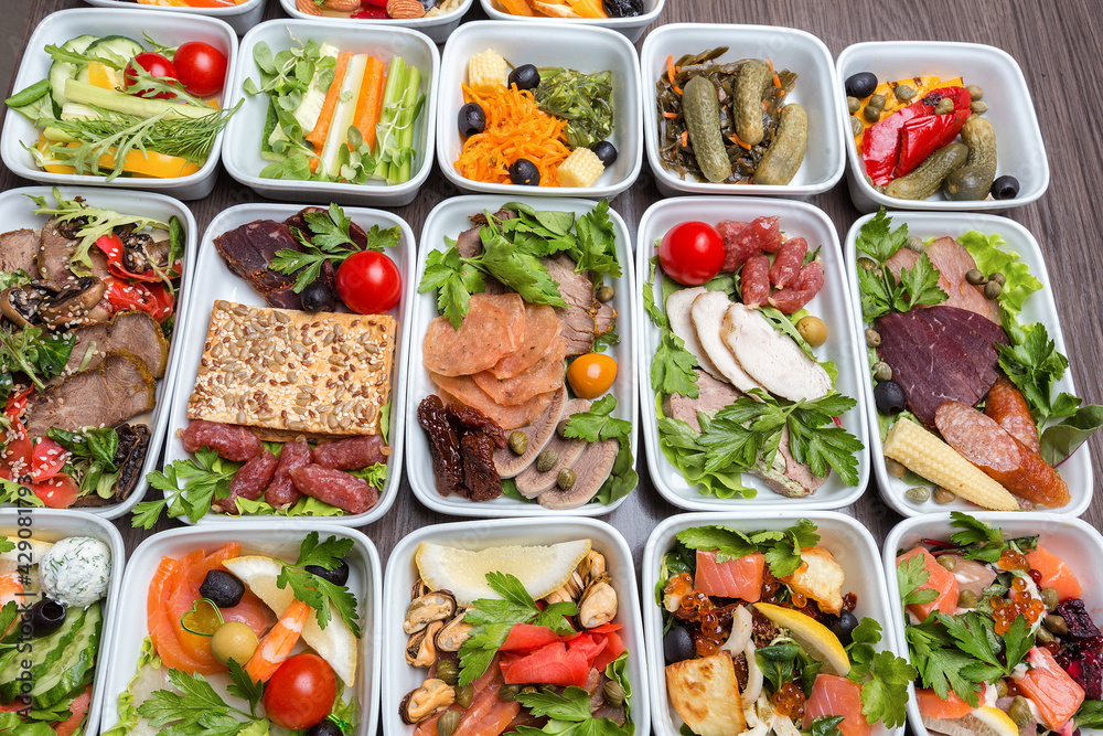 Airplane food presentation with variety of in flight meals. Flight ...