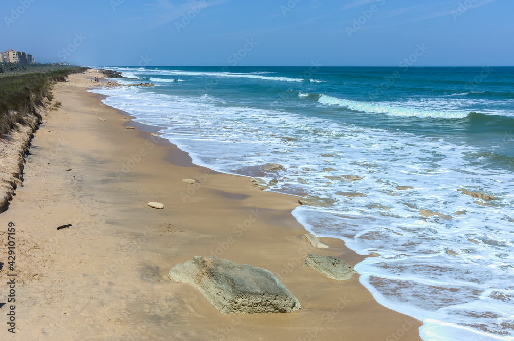 Coquina rocks exposed during low tide along the shoreline of Flagler ...
