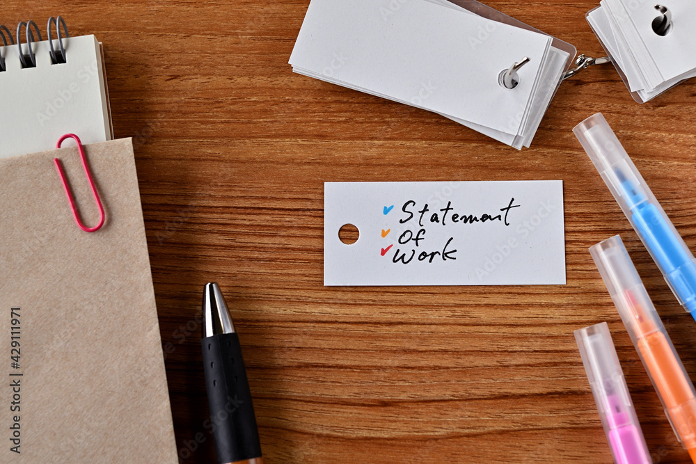 There is word book and colored pens with the word Statement Of Work ...