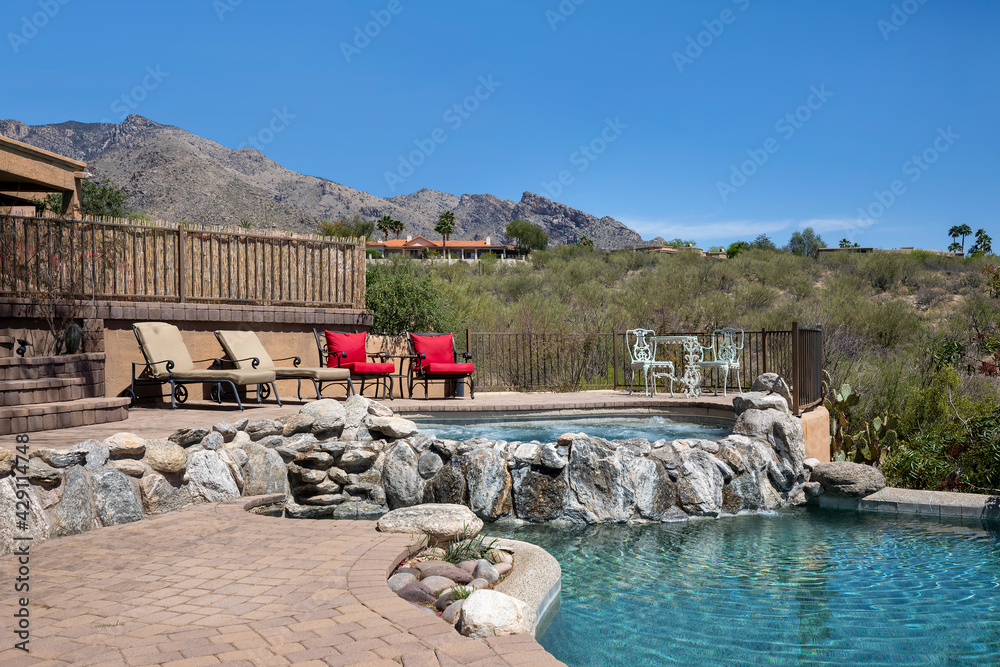 Swimming pool with hot tub and terraced patio at a luxury home in a ...