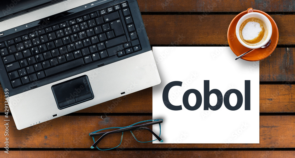 Cobol programming language. Word Cobol on paper and laptop Stock Photo ...
