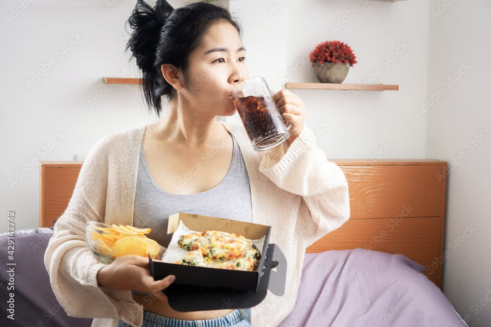 lazy woman eating junk food hand holding box of pizza and bowl of ...